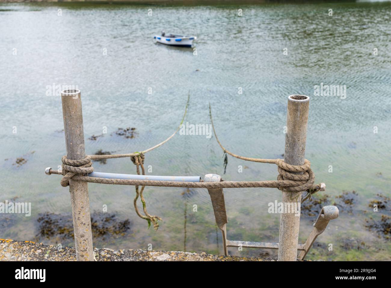 Step ladder leading down to running mooring for boat in Salcombe ...