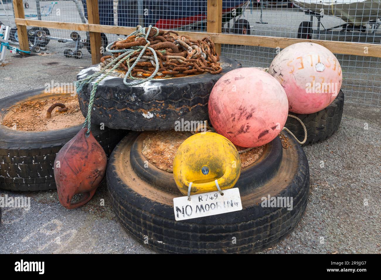 Old tyres filled with concrete with rusty chain attached for holding ...