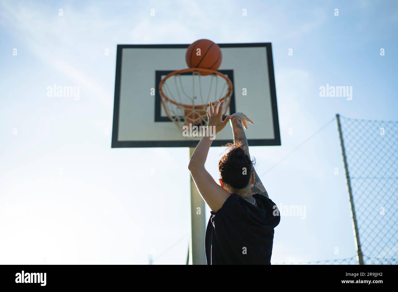 From below back view of anonymous female basketball player throwing ...