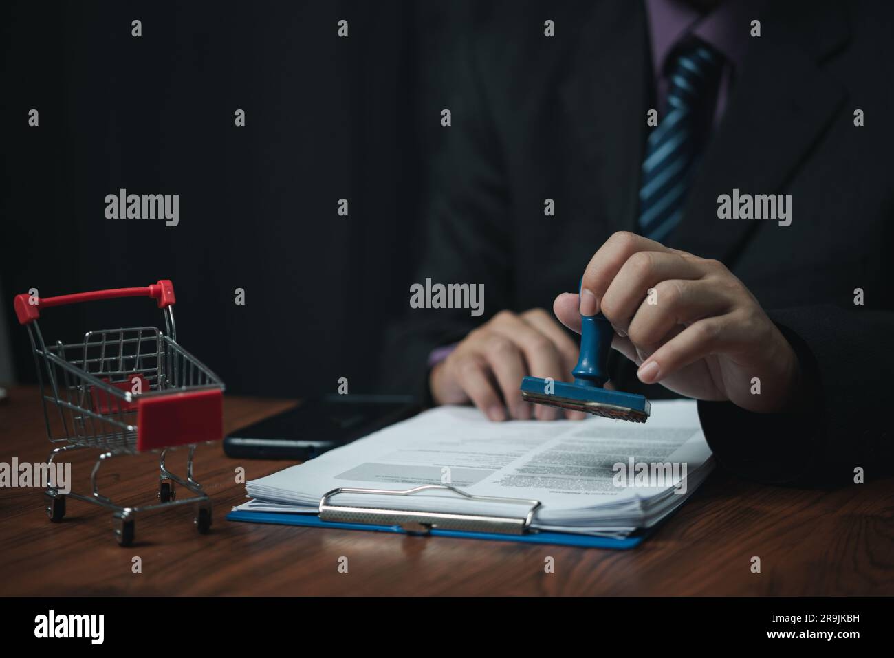 Man hand stamping approval signing on document or paperwork contract at ...