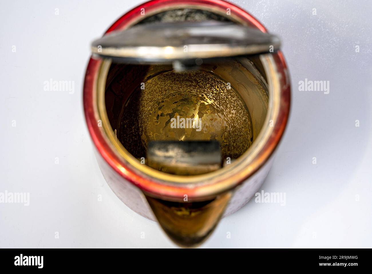 An old electric kettle with traces of scale and limescale on the walls ...