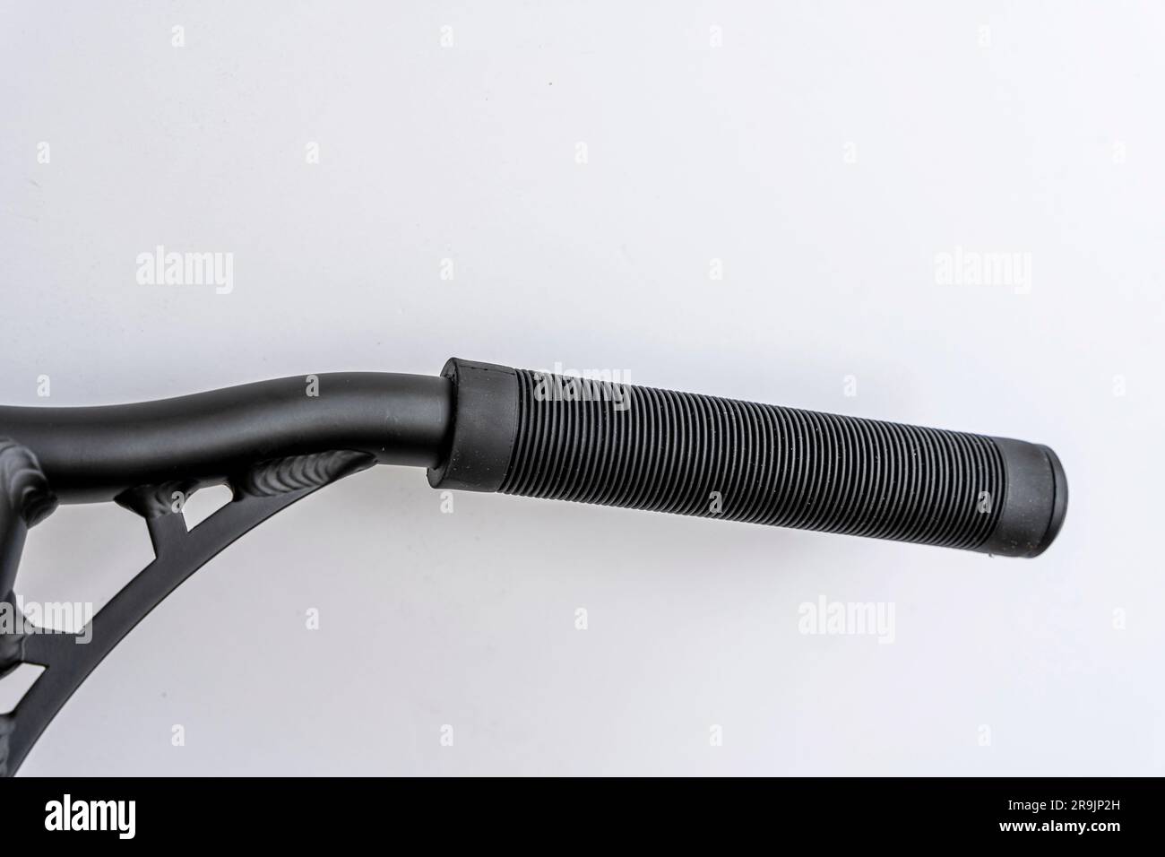 the handle bar of a stunt scooter with black rubber comfortable grips ...