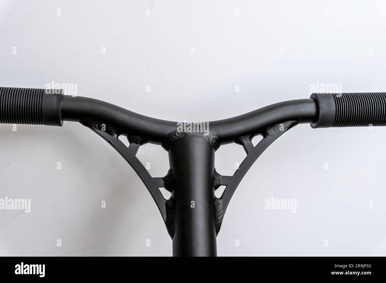 the handle bar of a stunt scooter with black rubber comfortable grips ...