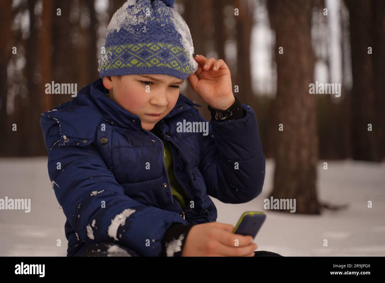 A business boy reads disturbing stock market reports in between winter ...