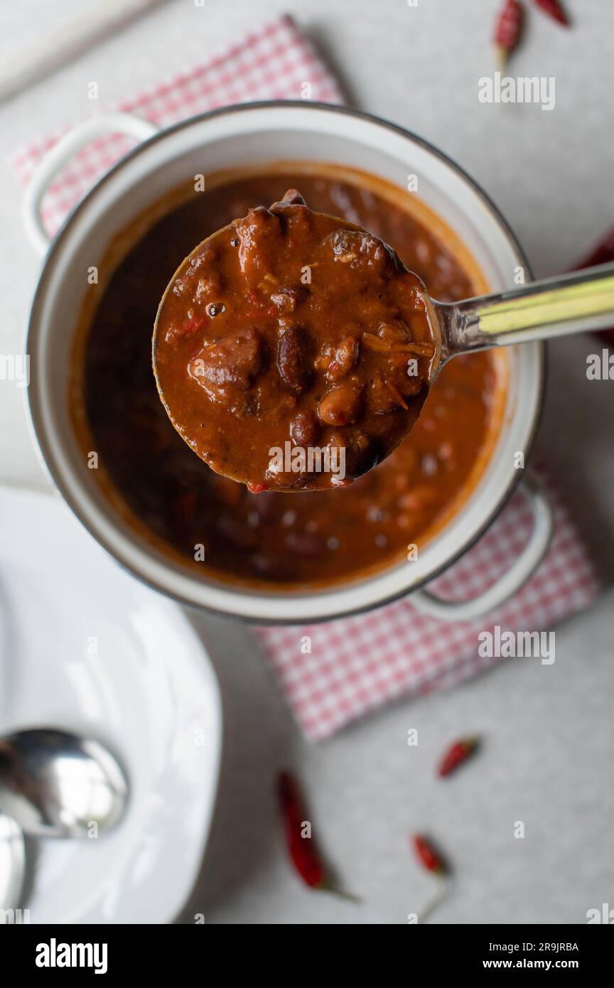 A ladle full with delicious bean, beef stew from above Stock Photo - Alamy