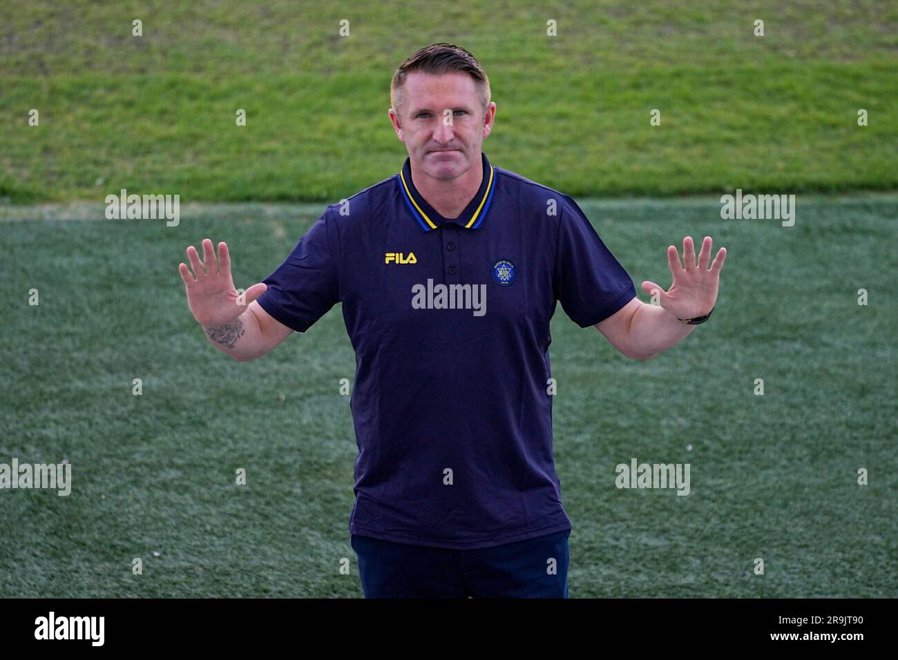 Former Ireland soccer great Robbie Keane poses for photographers in Tel ...
