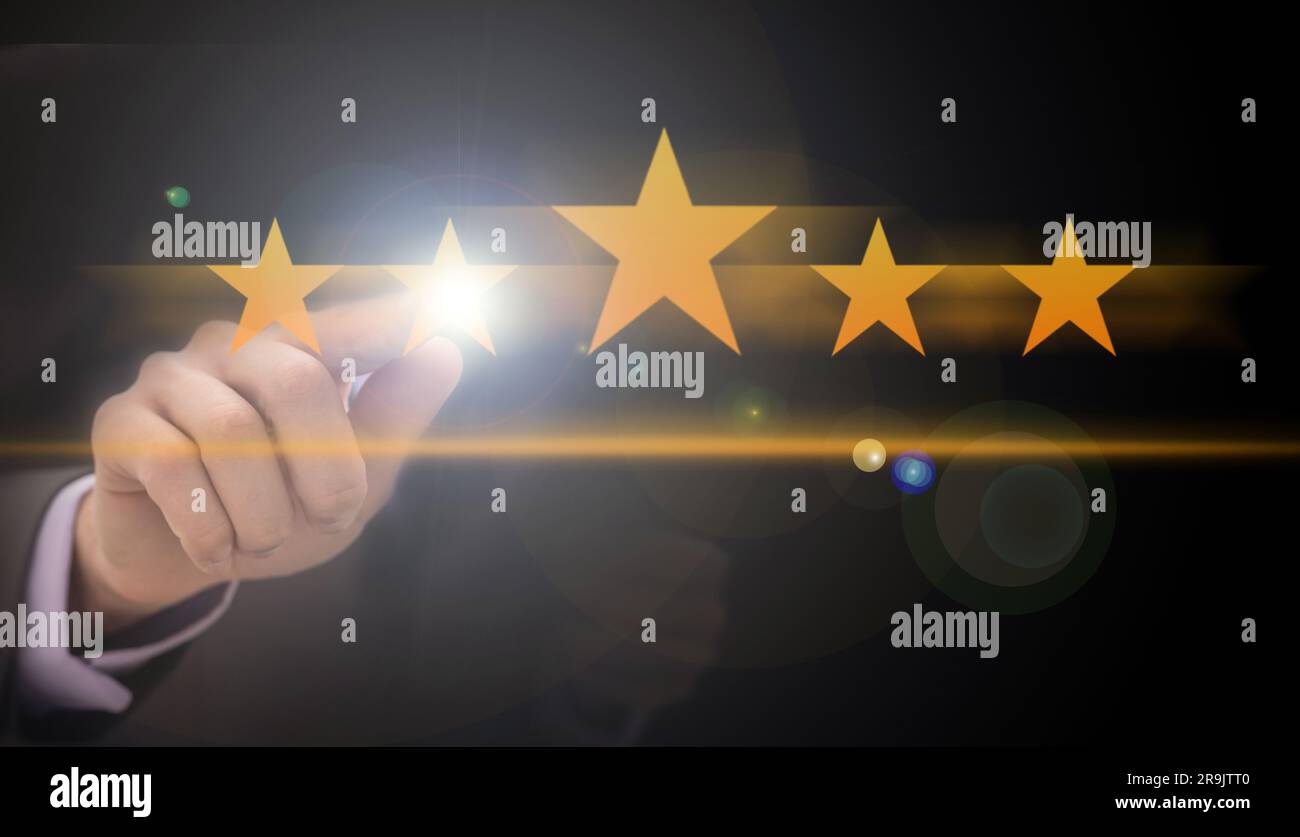 The person's hand pointing at hovering stars. Rating, evaluation Stock ...