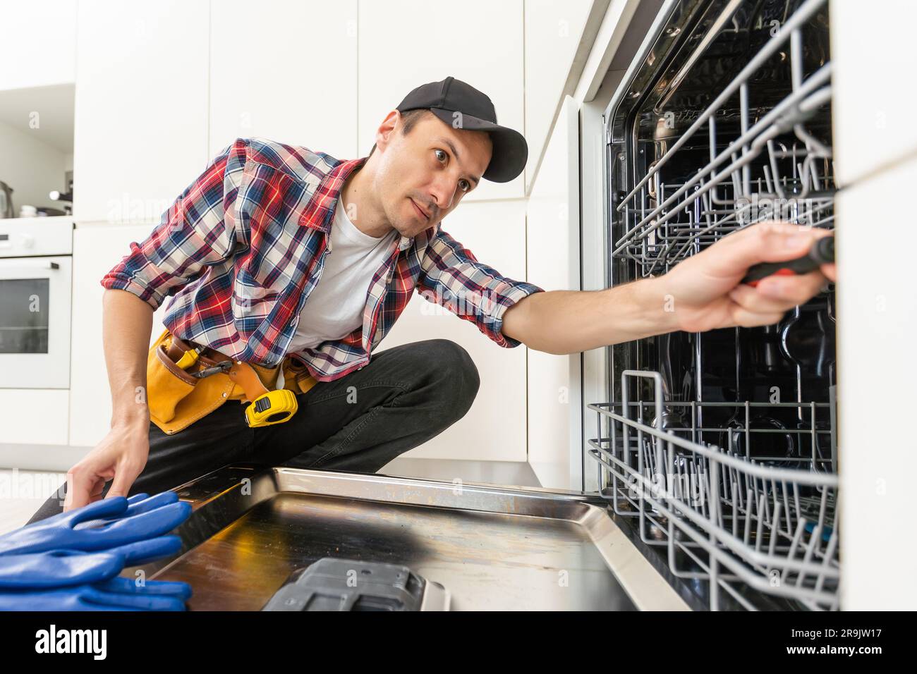 One repairman fixing malfunctioning kitchen dishwasher problem Stock ...
