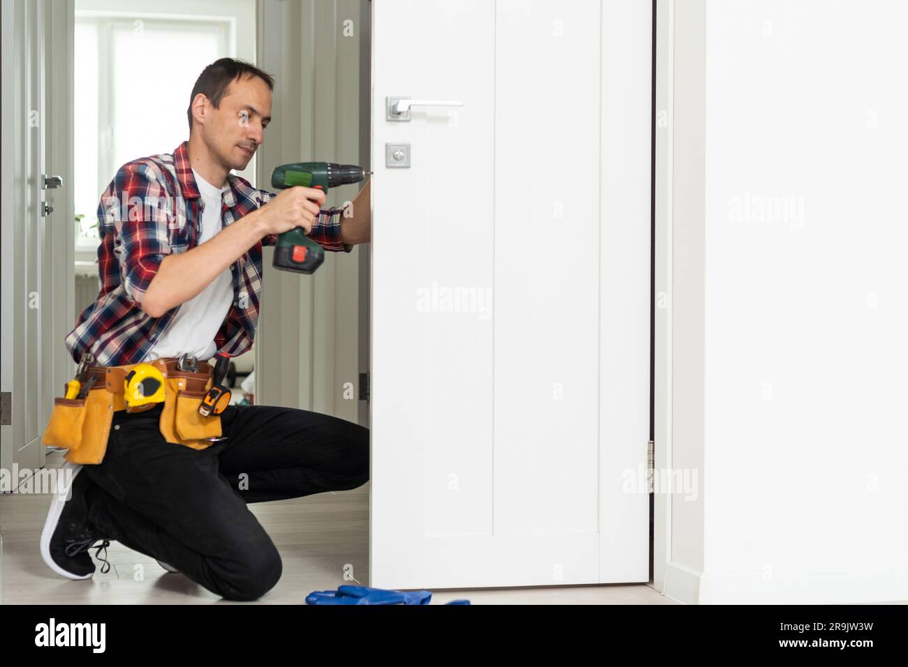 Maintenance Concept. Focused serious young locksmith with tattoo on ...