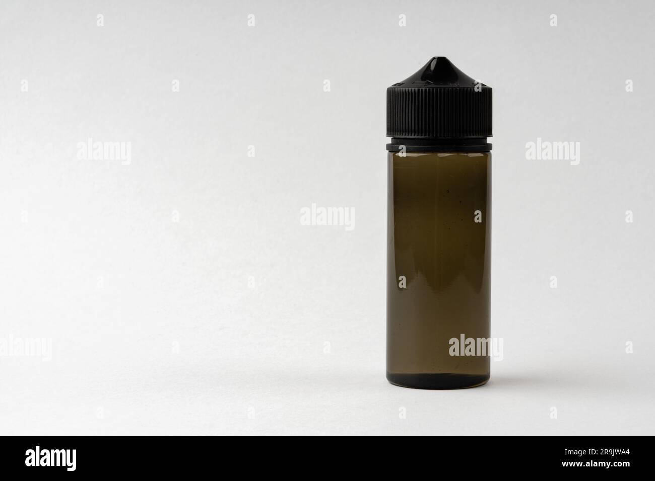 Small black glass dropper bottle front view on gray background Stock ...