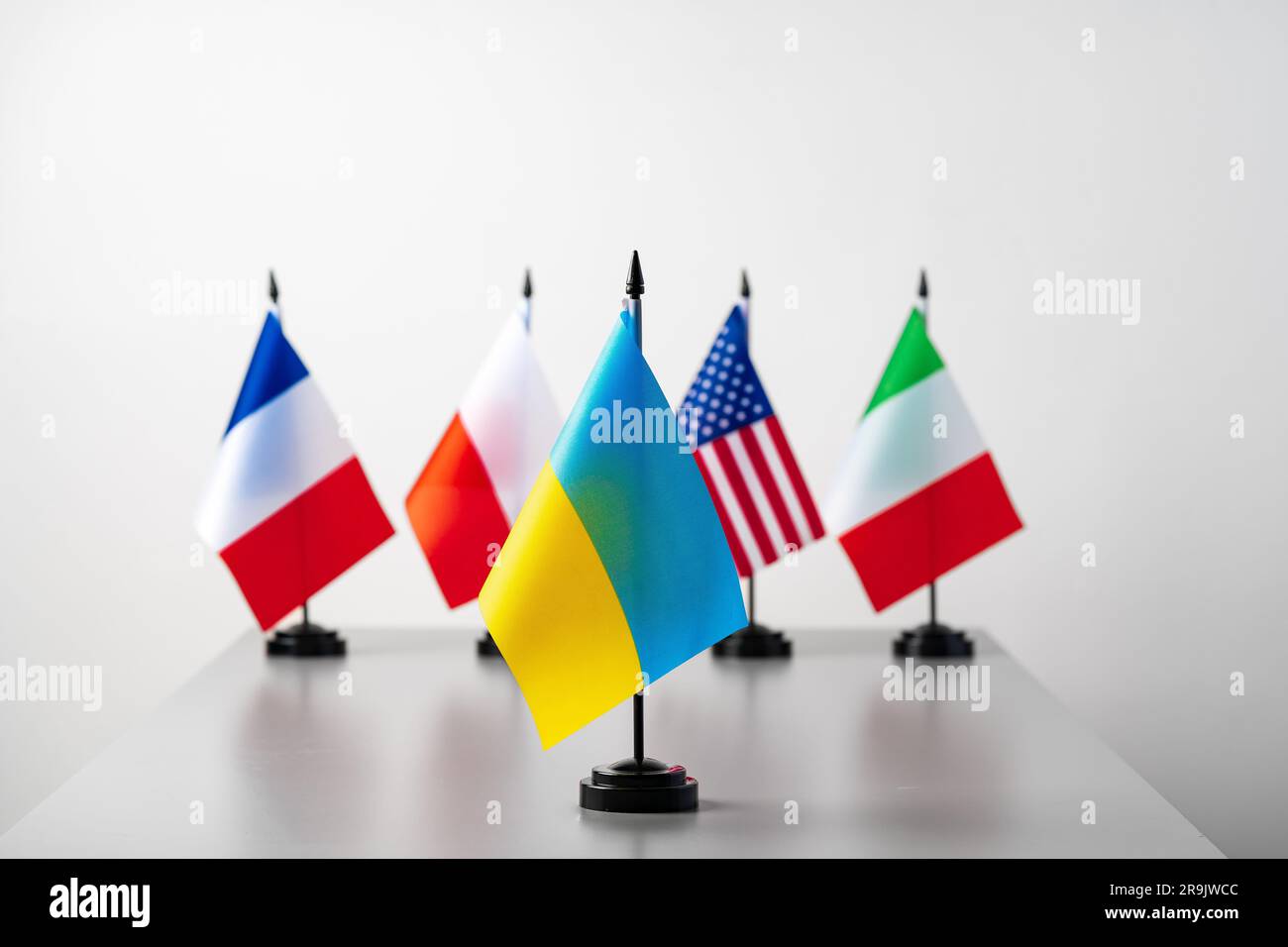 Small country flags standing at a table Stock Photo - Alamy