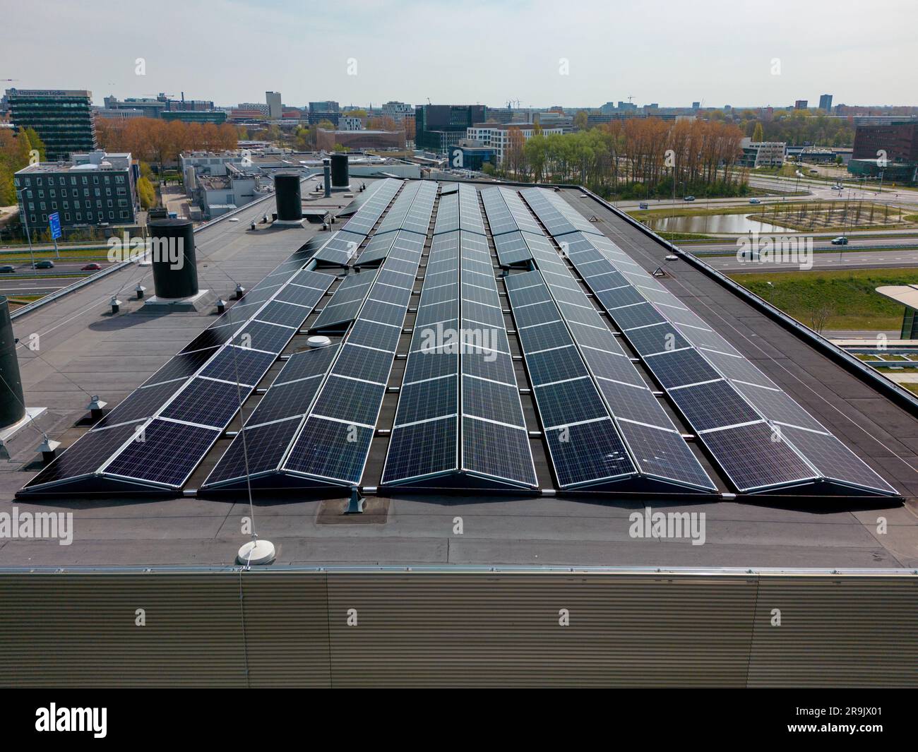 This drone video shows an office roof with many solar panels for green ...