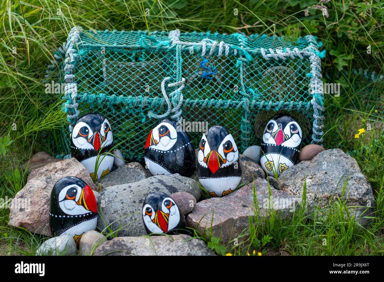 Seaside art. Hand painted puffins and a lobster creel in a garden at ...
