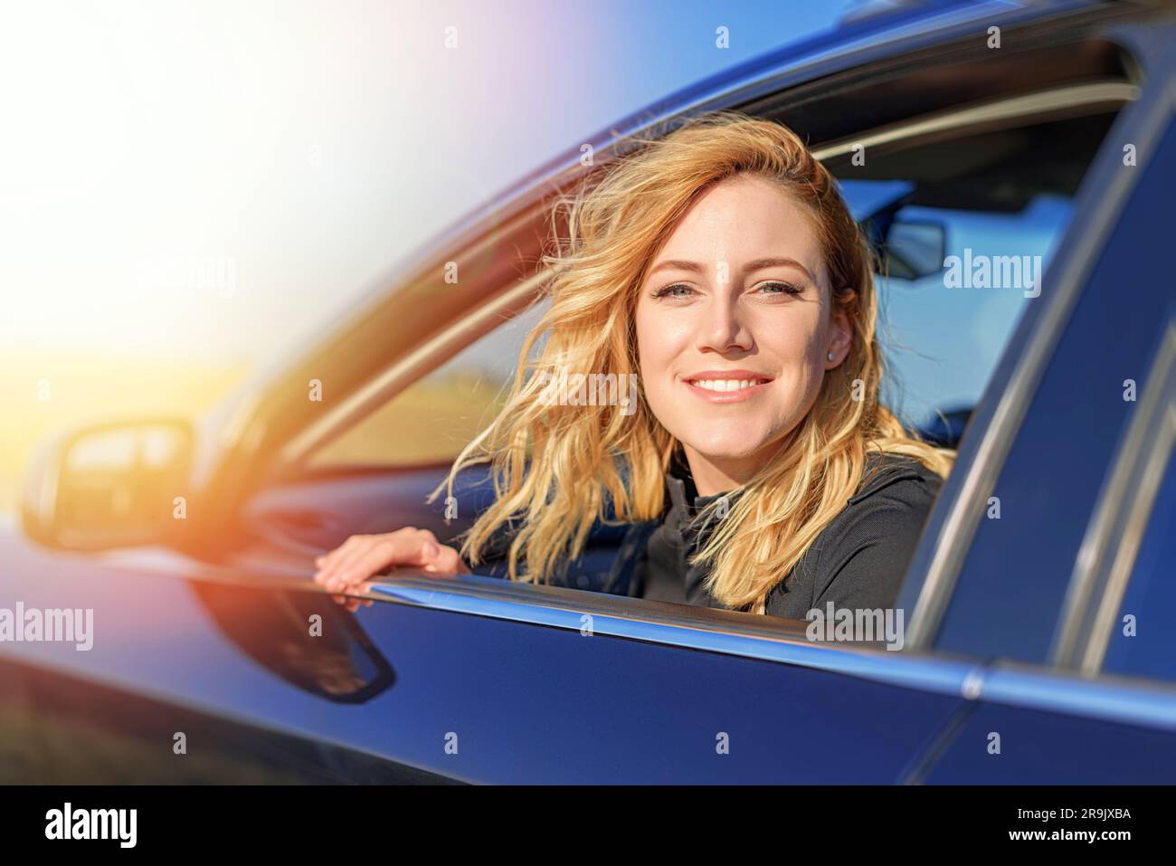 Beautiful blonde woman driving a car Stock Photo - Alamy