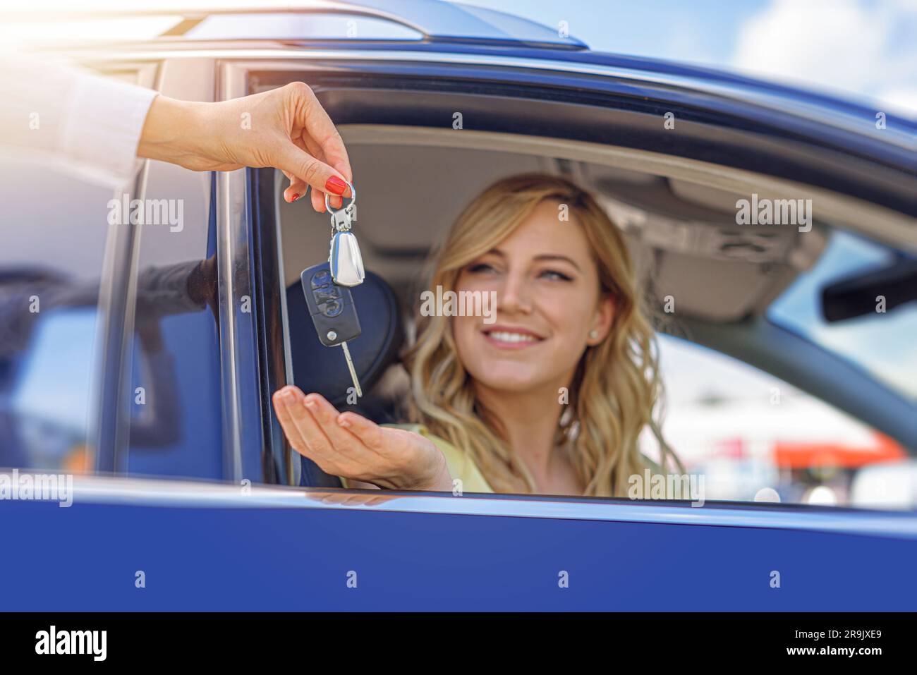 A woman's hand passes the key to the car Stock Photo - Alamy