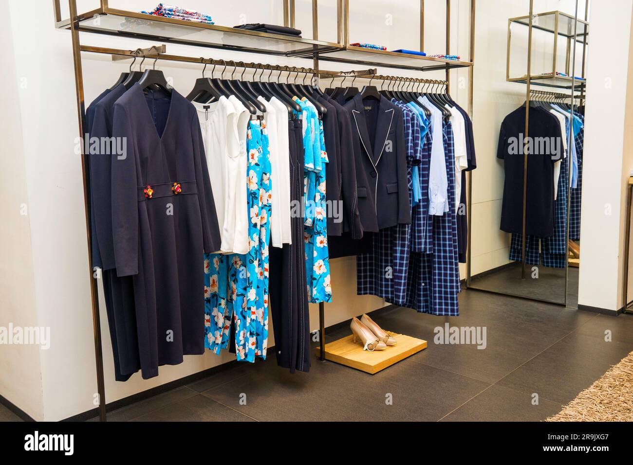 Interior of fashionable women's clothes store with clothes racks Stock ...
