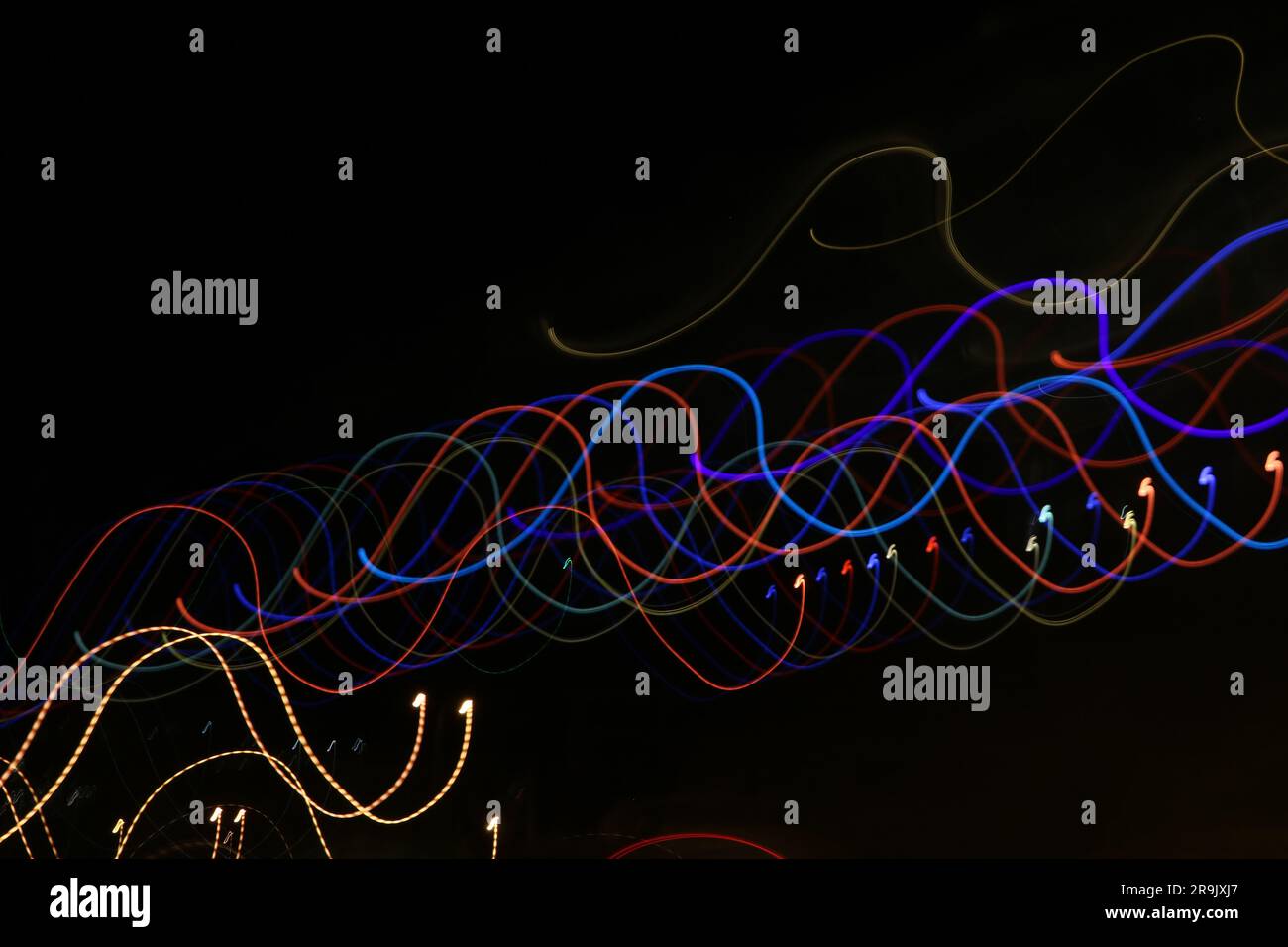 A time-lapse photograph of red and blue lights, illuminated against a ...