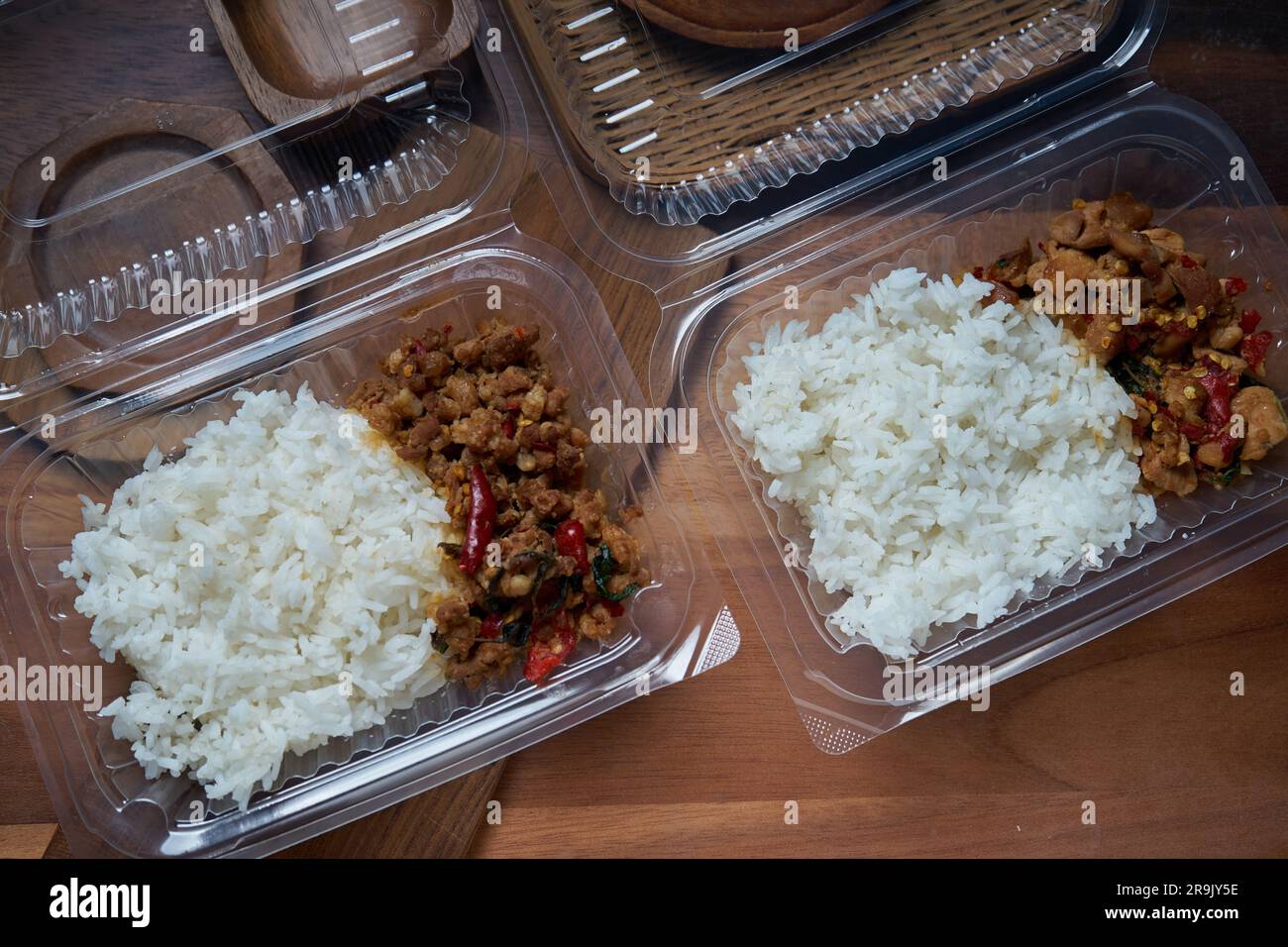 Rice with stir-fried pork and basil in the plastic box Stock Photo - Alamy
