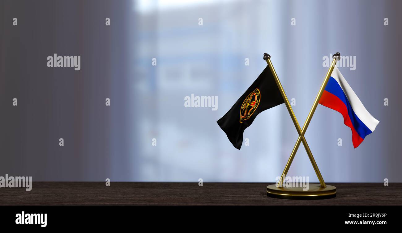 Russia and Wagner Group flags on table. Negotiation between Wagner and ...