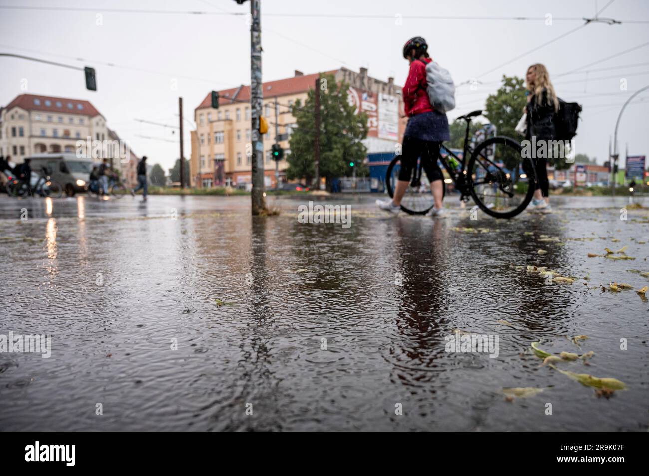 Berlin, Germany. 27th June, 2023. People walk across an intersection in ...