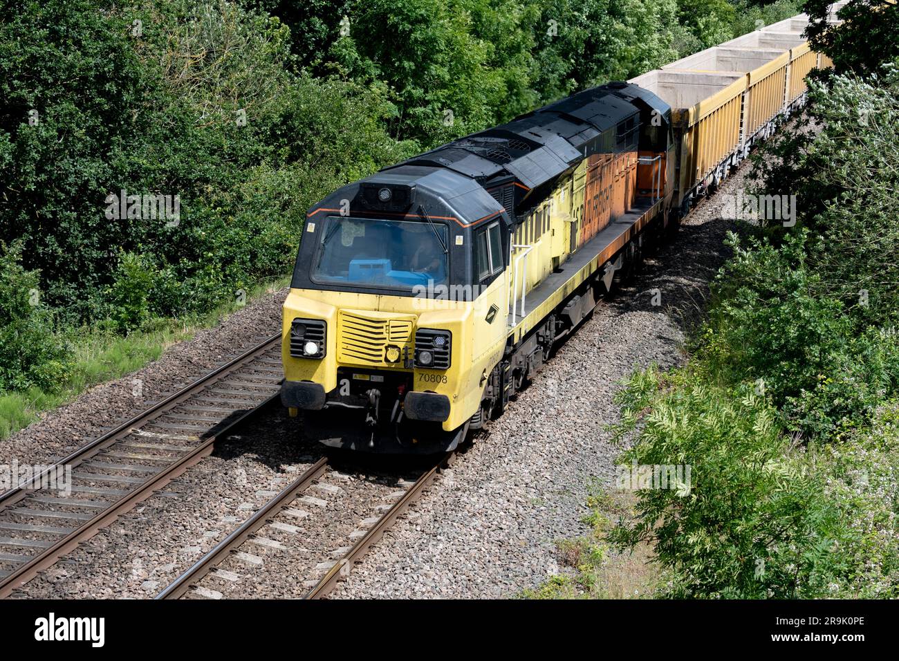 Colas class 70 diesel locomotive No. 70808 pulling empty ballast trucks ...