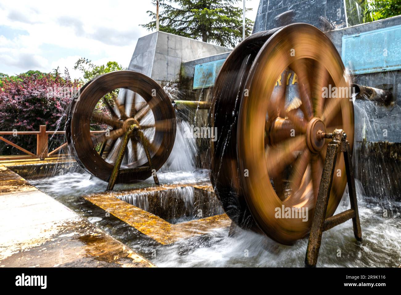 two watermills rotate with the flow of water Stock Photo - Alamy