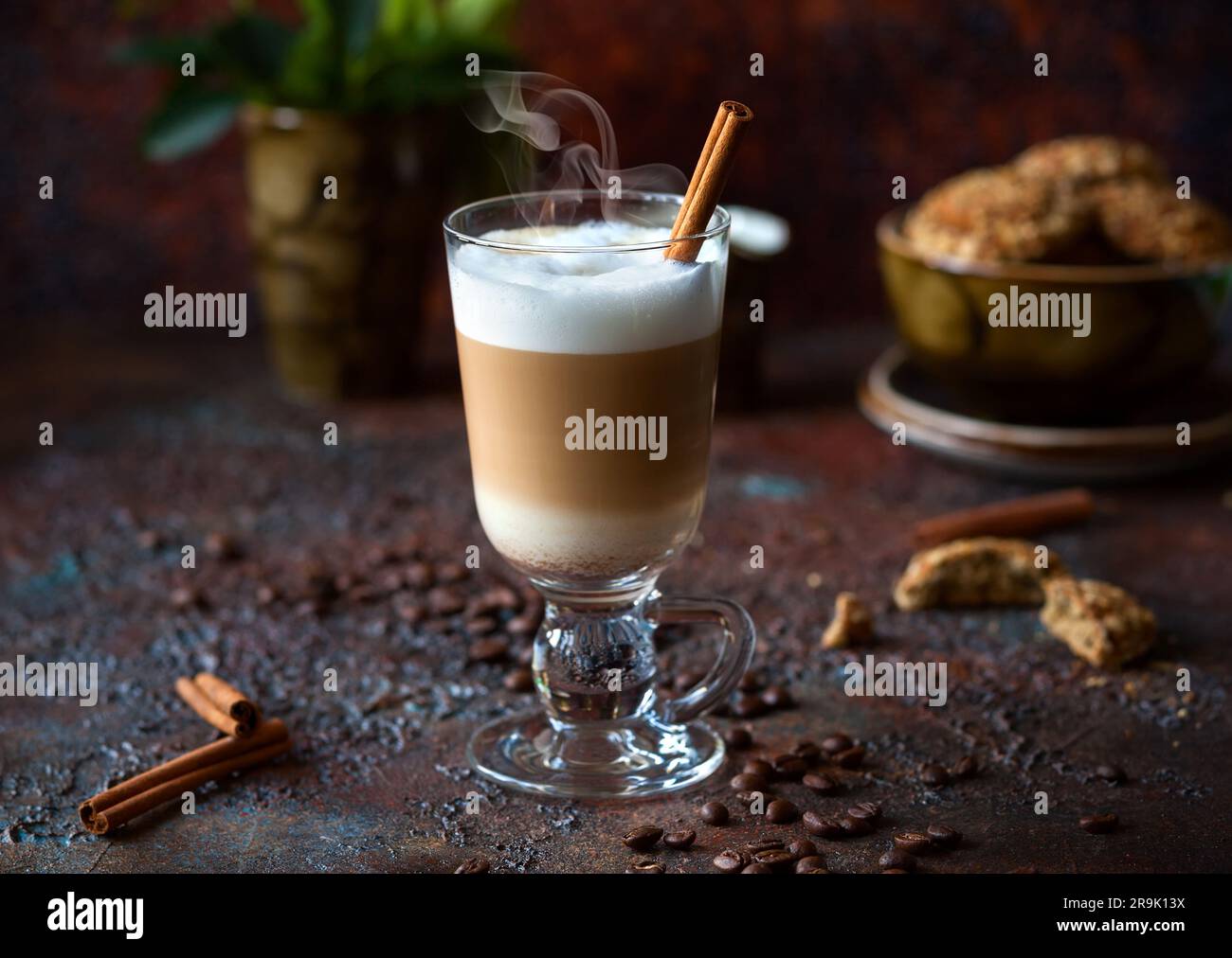Coffee latte in a tall glass with stick of cinnamon Stock Photo - Alamy