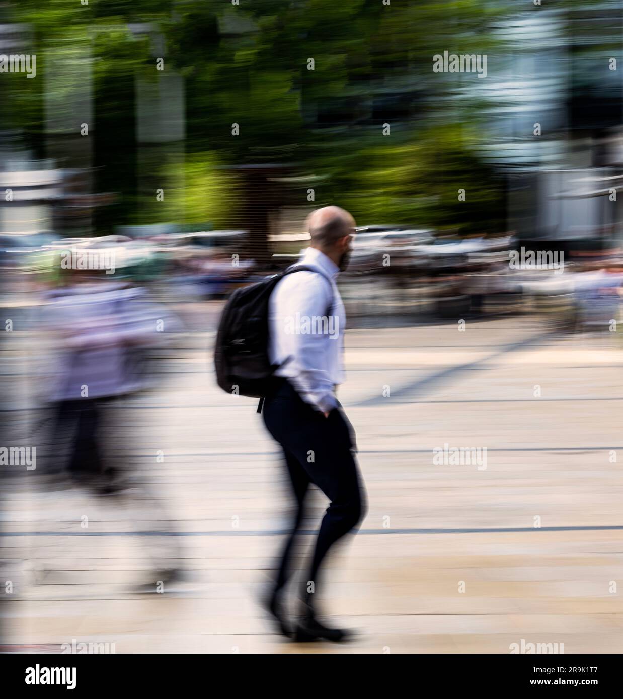 People moving at speed in King St in Hammersmith, London, blurred from ...