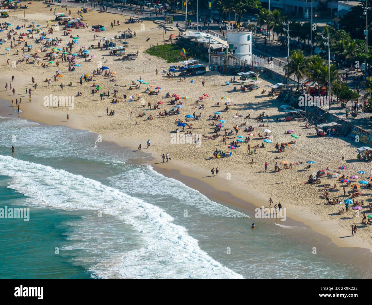 Aerial view of Ipanema beach. People sunbathing and playing on the beach, sea sports. Rio de ...
