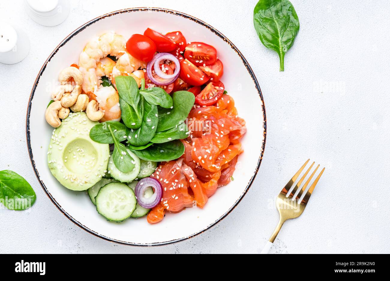 Keto salad with spinach, salmon, shrimp, avocado, cucumber, tomato ...