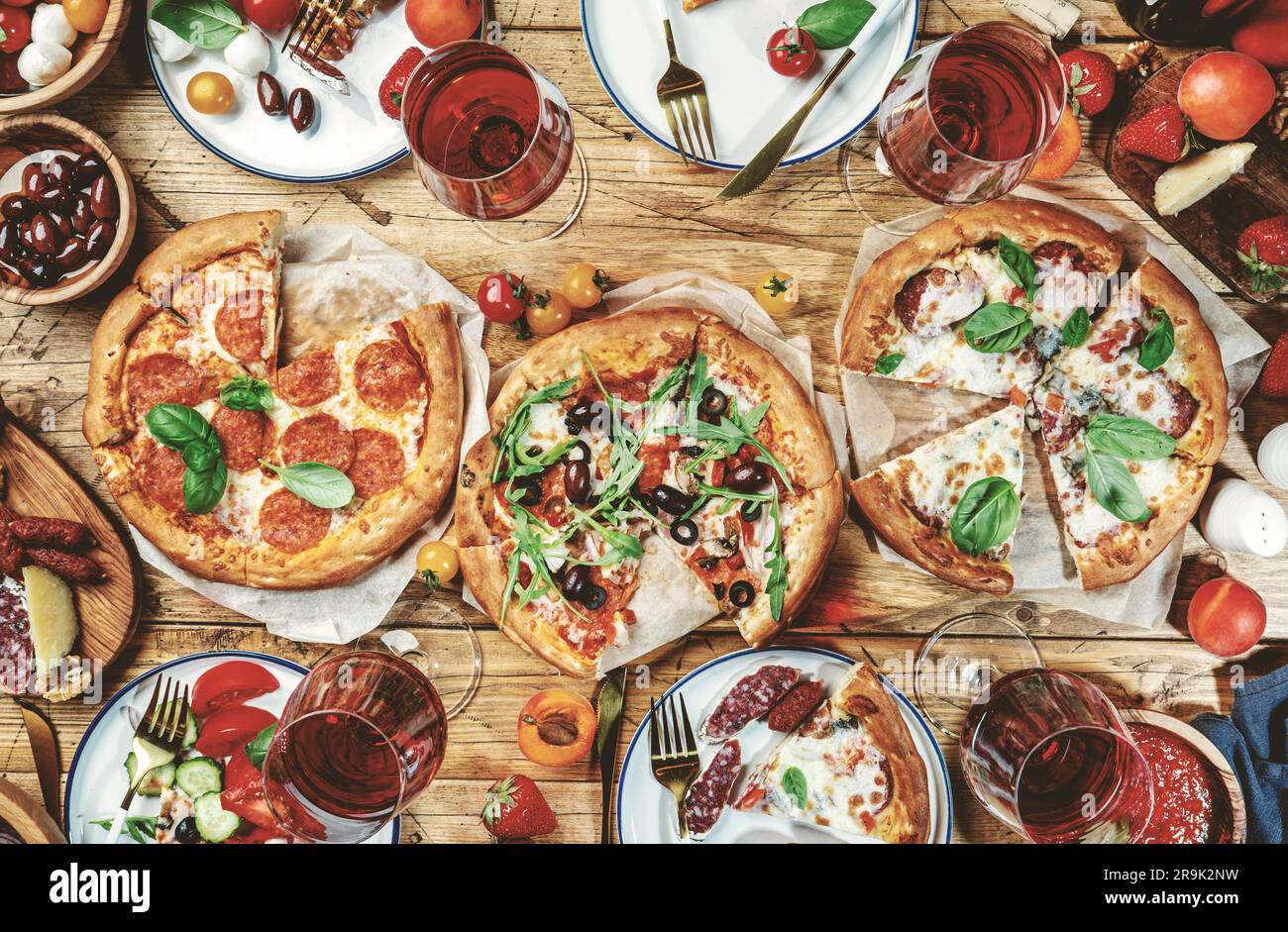 Pizza party table. Top view glasses with red wine, rustic wooden table ...