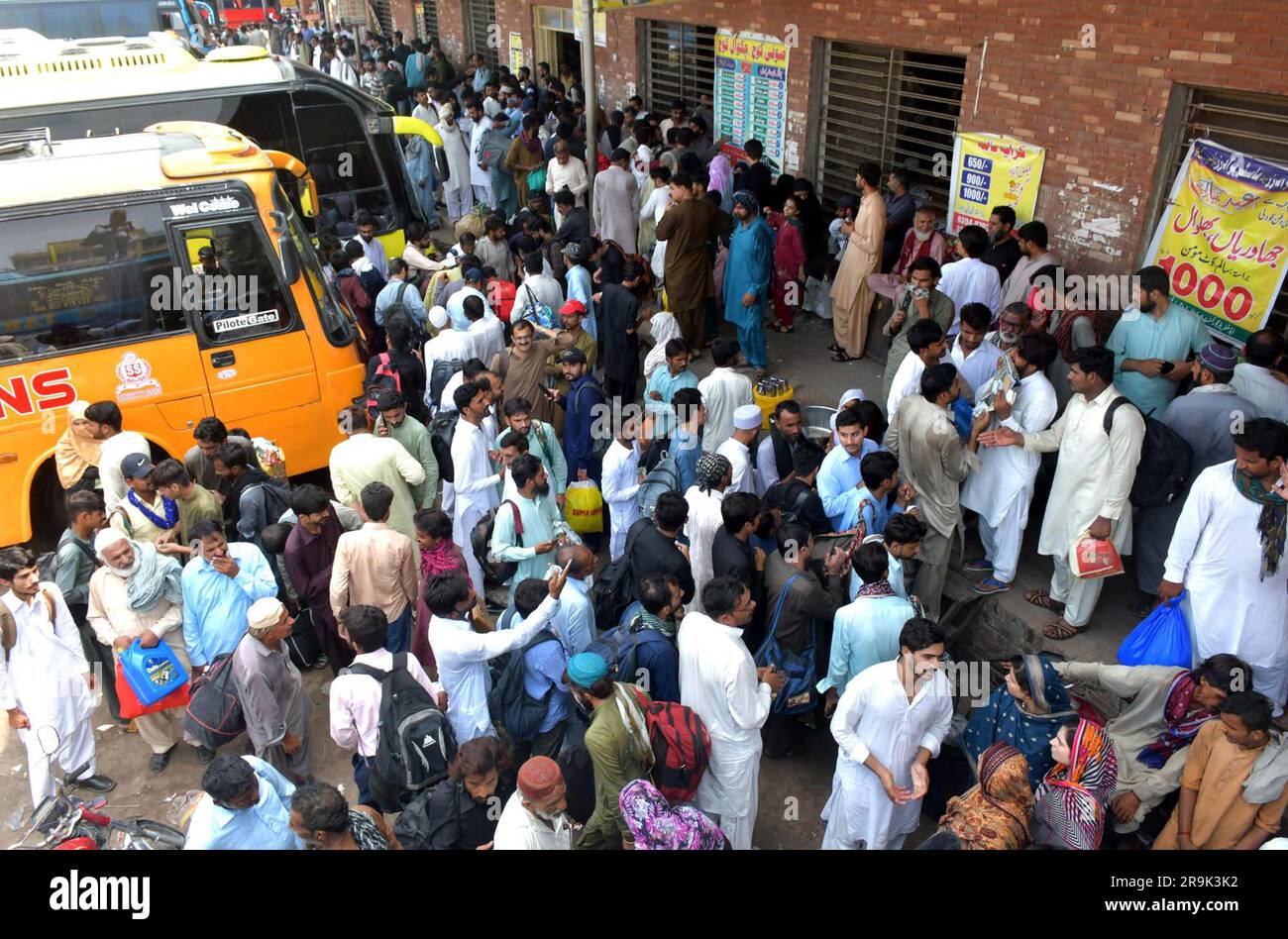 Karachi, Pakistan, June 27, 2023. People to board on bus as they are ...