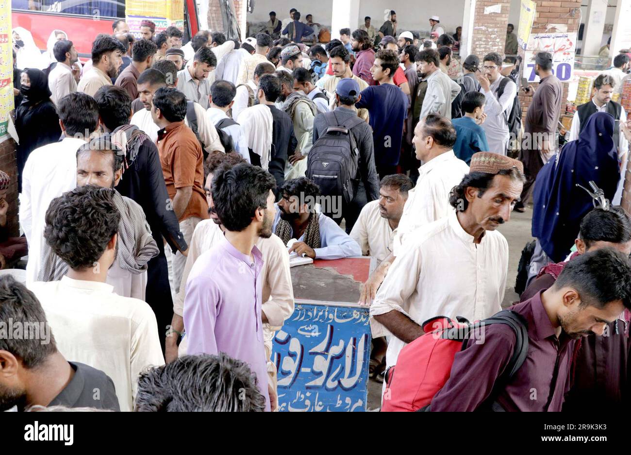 Karachi, Pakistan, June 27, 2023. People to board on bus as they are ...