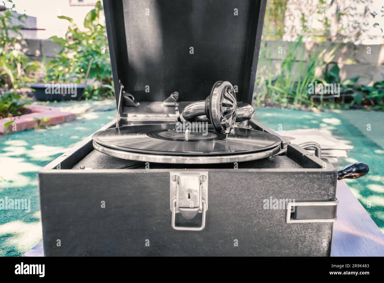 old gramophone needle player on a vinyl record. Round shiny metal ...