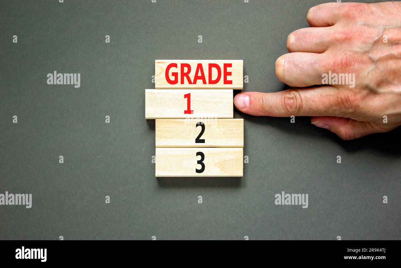 Time to grade 1 symbol. Concept word Grade 1 2 3 on wooden block ...