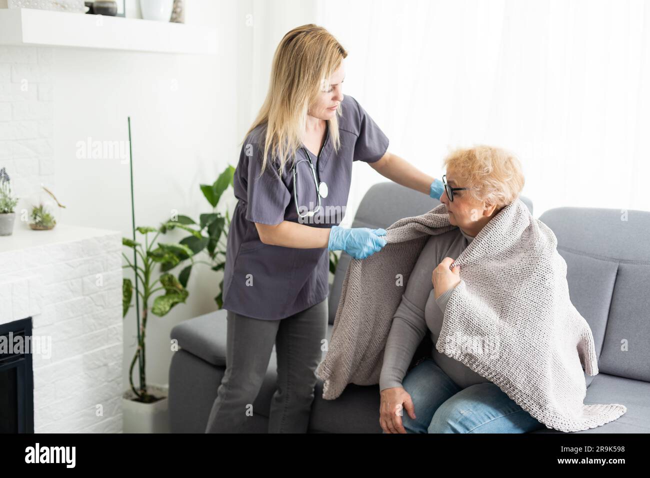 Caring young nurse doctor carer helping holding hands of happy disabled ...