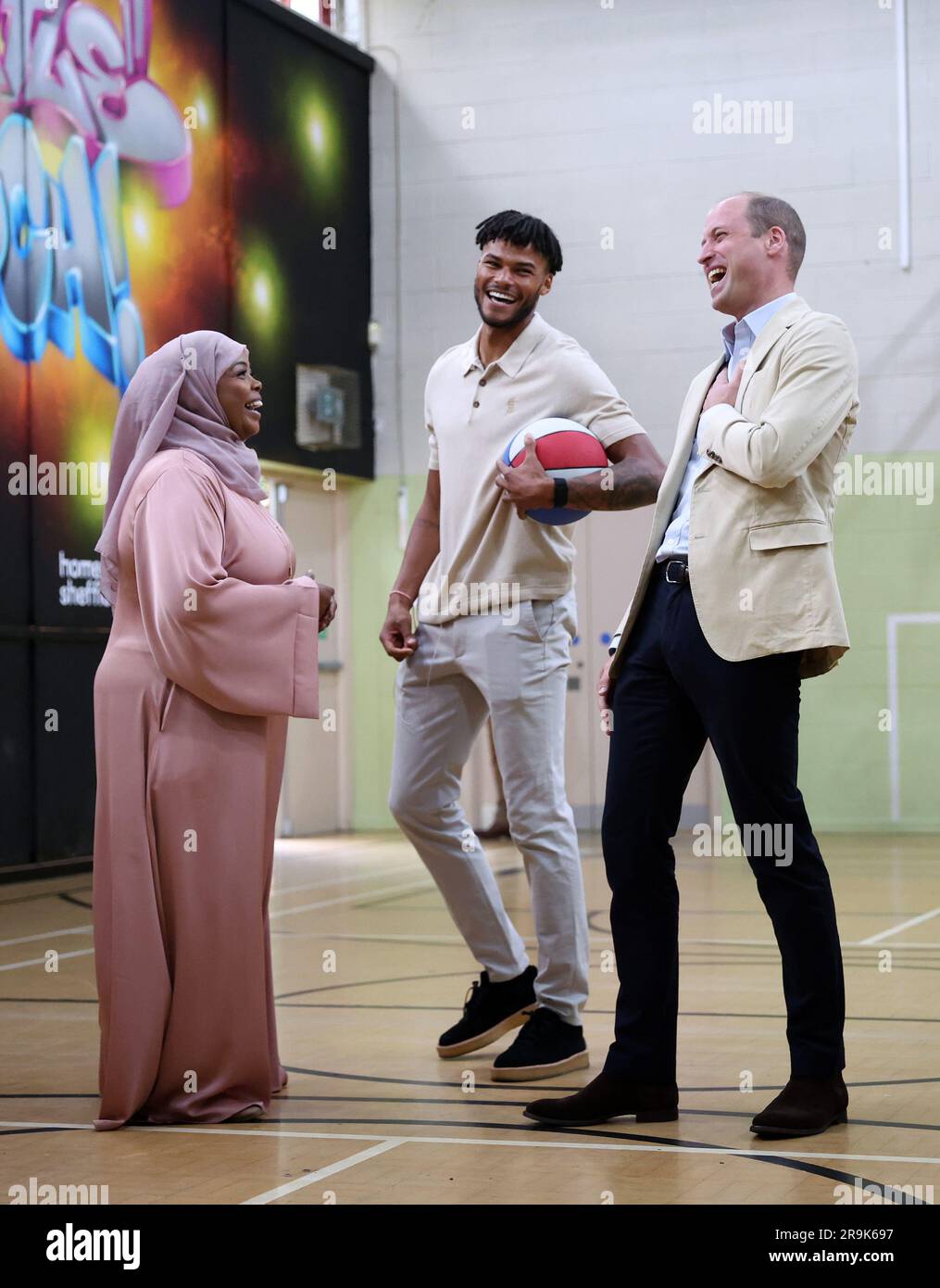 The Prince of Wales laughs with footballer Tyrone Mings (centre) during ...