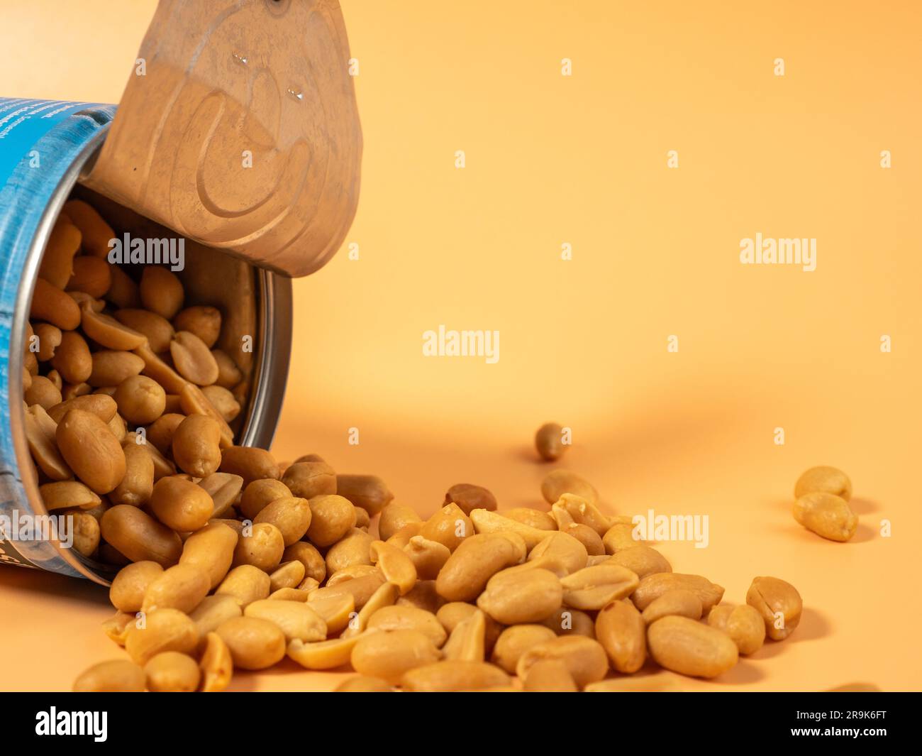 Roasted peanuts in an open jar on orange. Peanuts close up Stock Photo ...