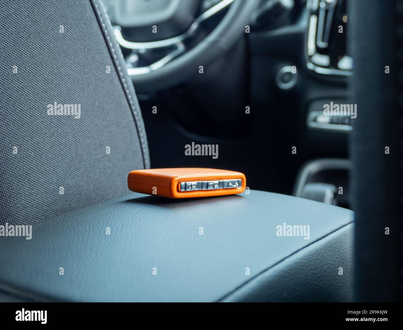 Car ignition key on the armrest in the interior of a modern car. Forgot ...