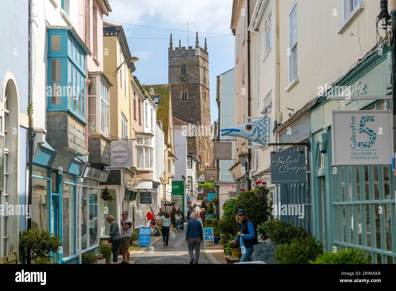 Shops in historic buildings along alleyway with tower of church of St ...