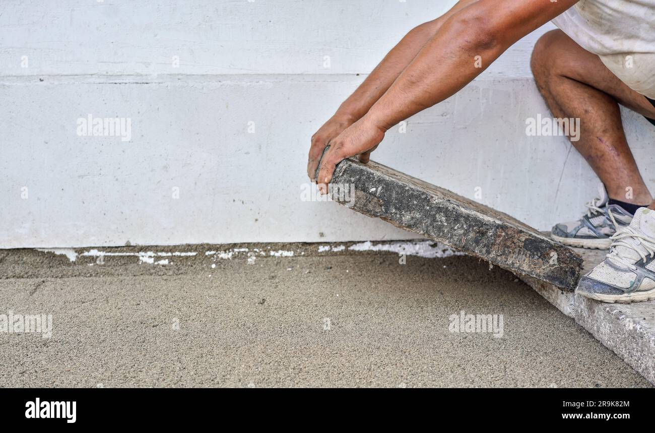 Installing new pavement or floor outside from large concrete tiles ...