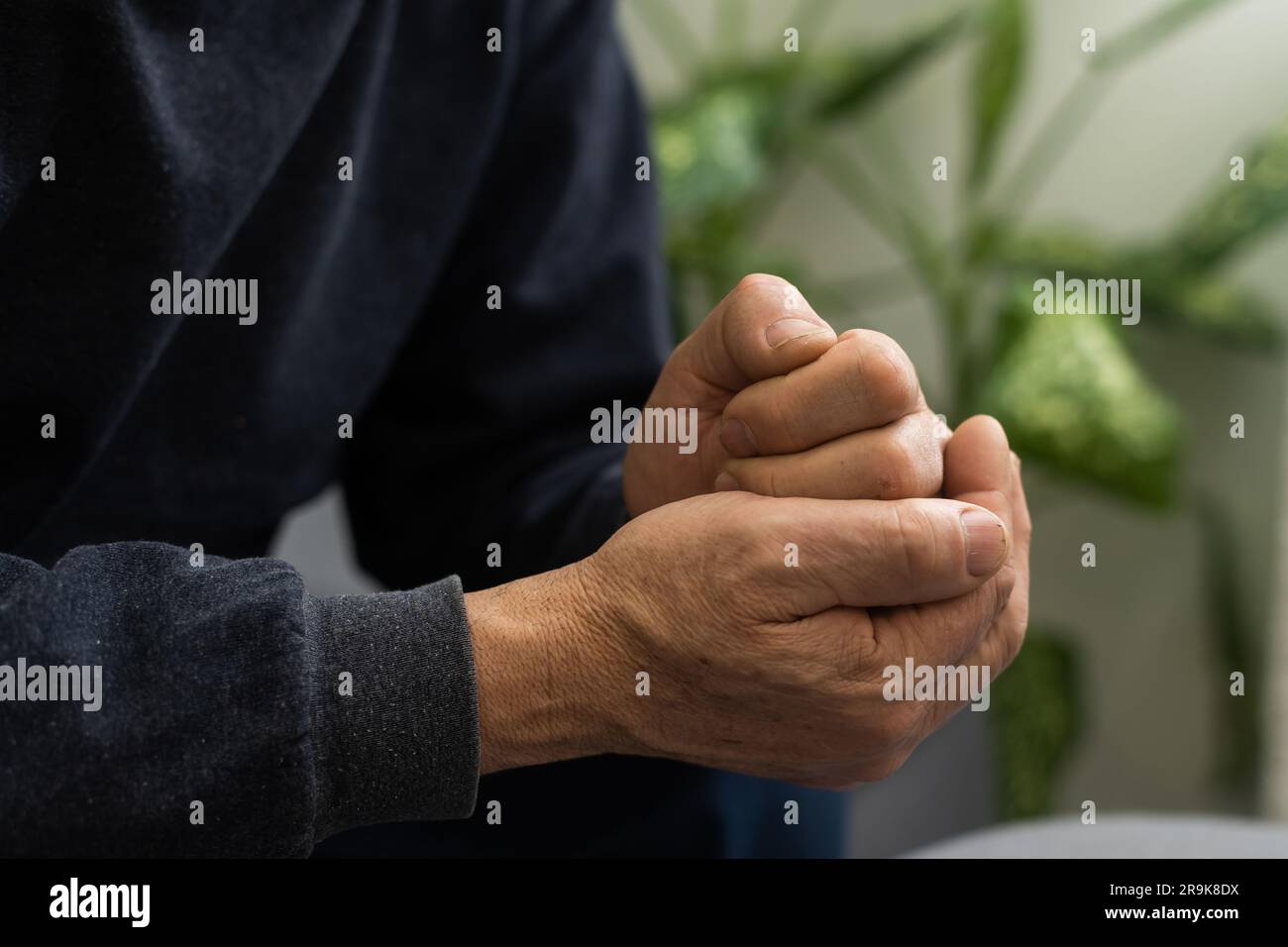 Please, Lord. Nervous worried aged Caucasian man praying on couch at ...