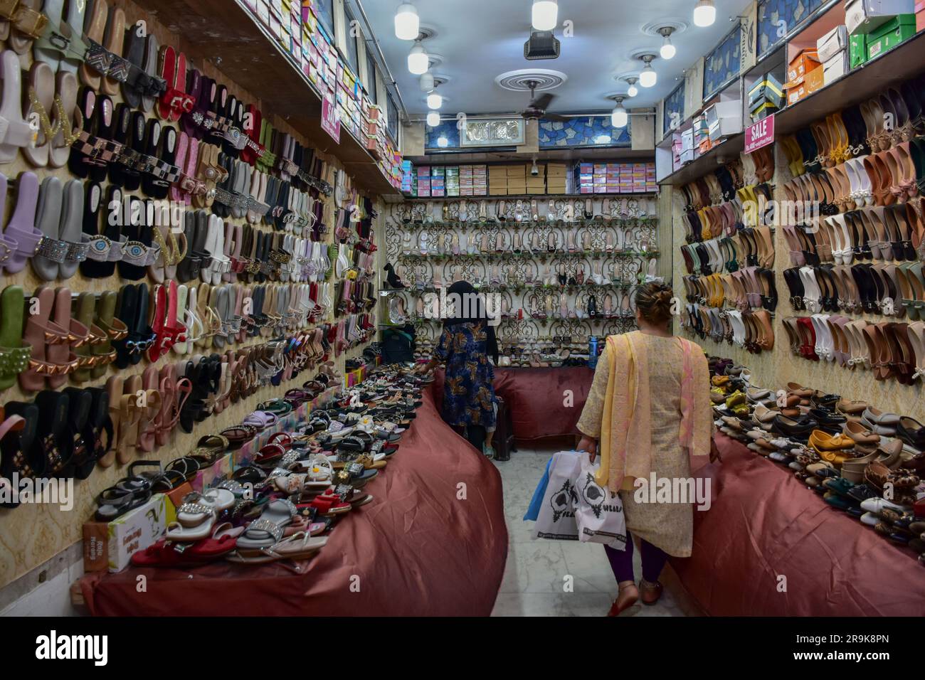 Srinagar, India. 27th June, 2023. Kashmiri Muslim women shop at a shoe ...