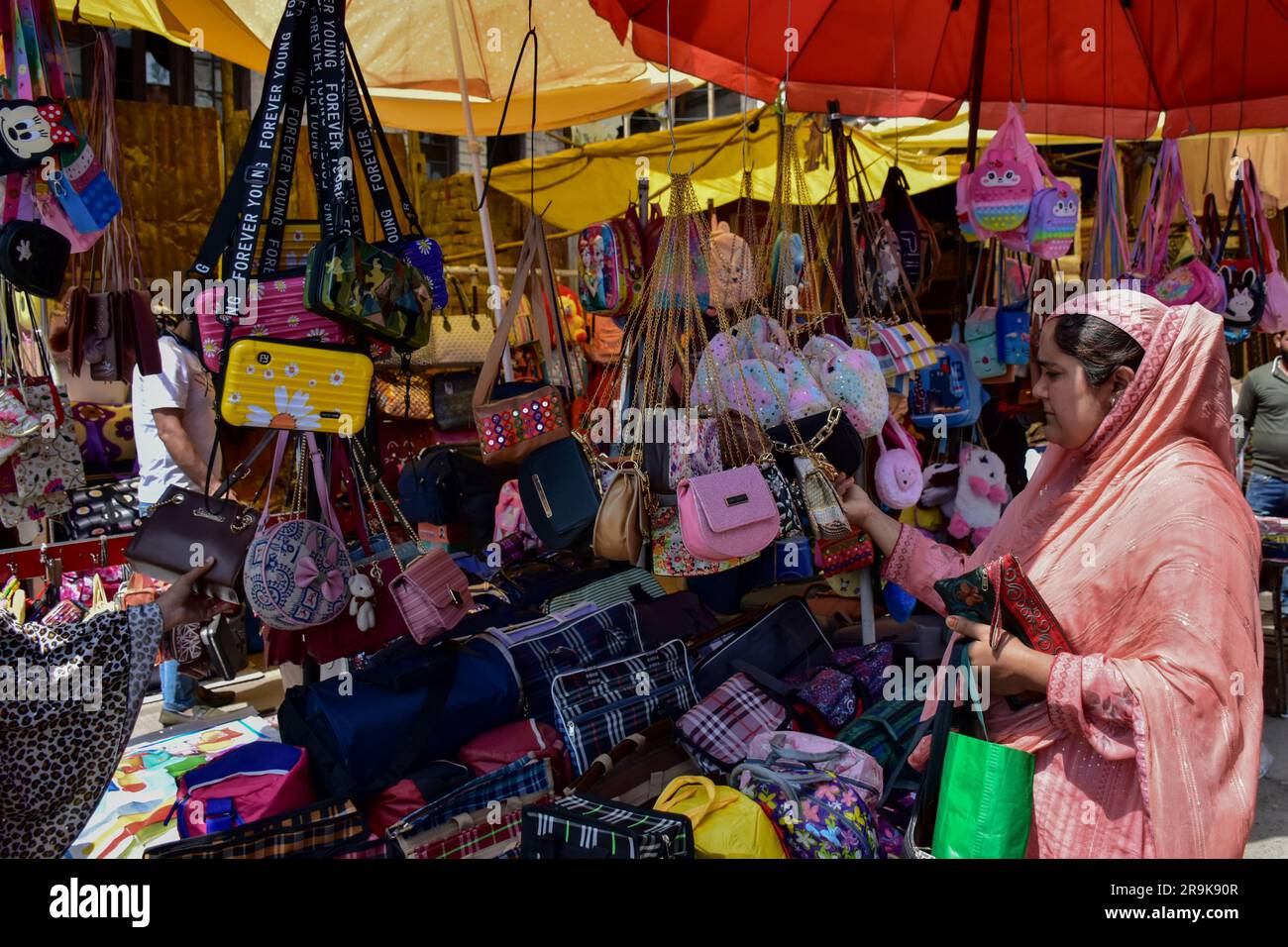 Srinagar, India. 27th June, 2023. A Kashmiri Muslim woman shops ahead ...