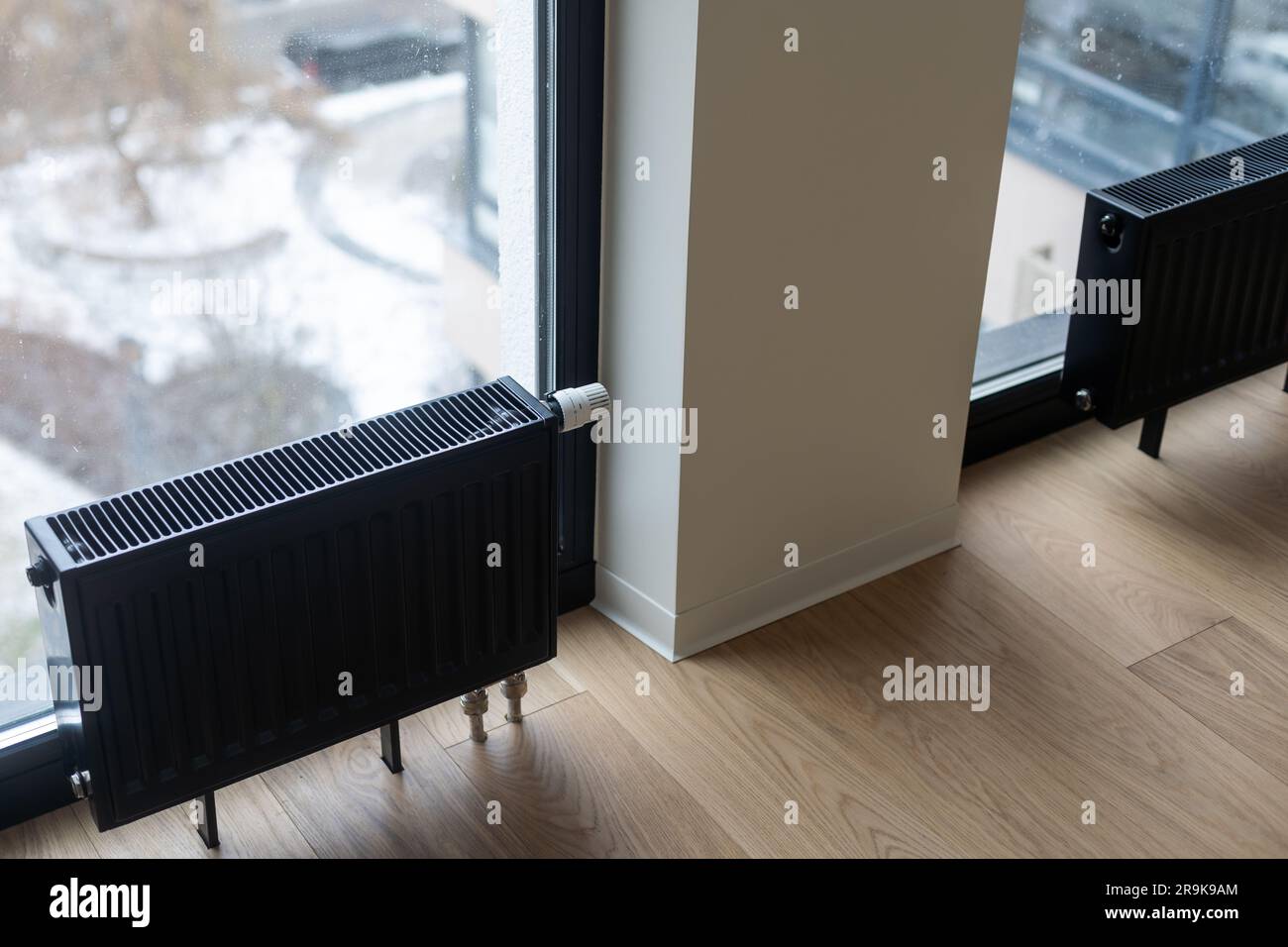 Detail of a modern black radiator under the window of a kitchen Stock ...