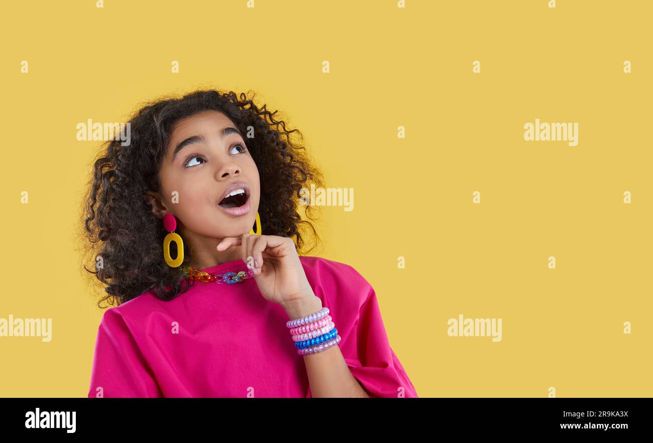 Funny ethnic preteen girl with omg facial expression looks at copy ...