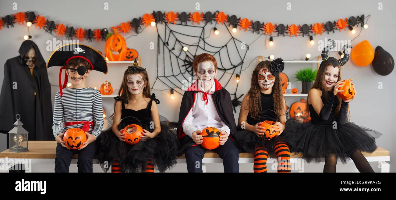Banner with group of happy trick or treaters dressed up in spooky ...