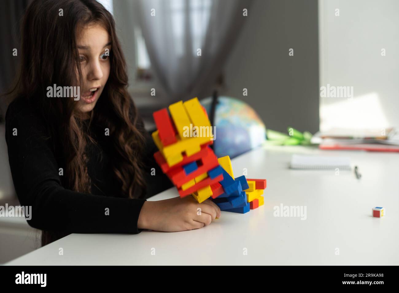 Children building wood blocks at playground. Girl kid playing stacking ...