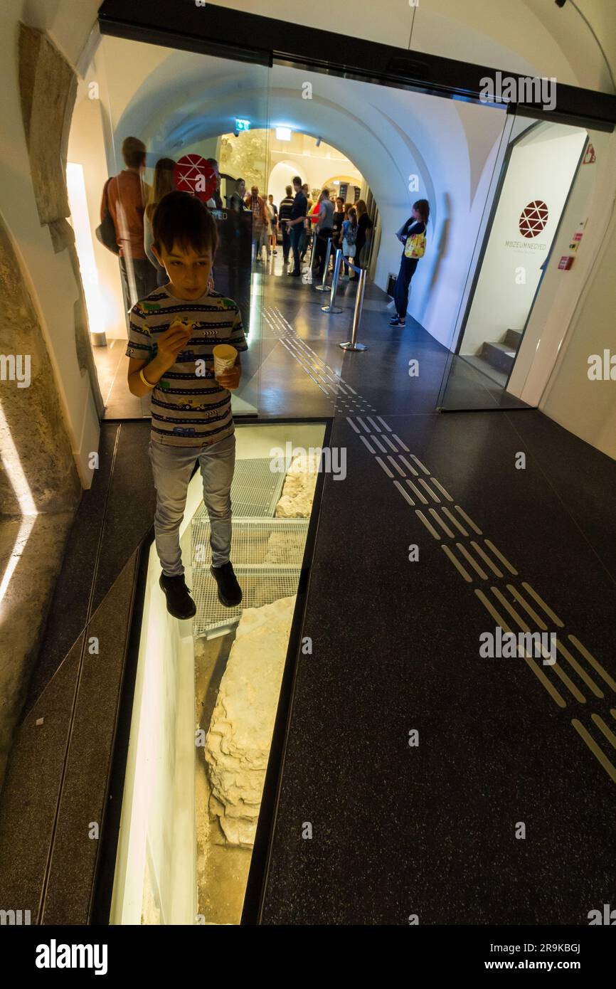 Child standing on glass floor at entrance of 'Muzeumnegyed' (Museum ...