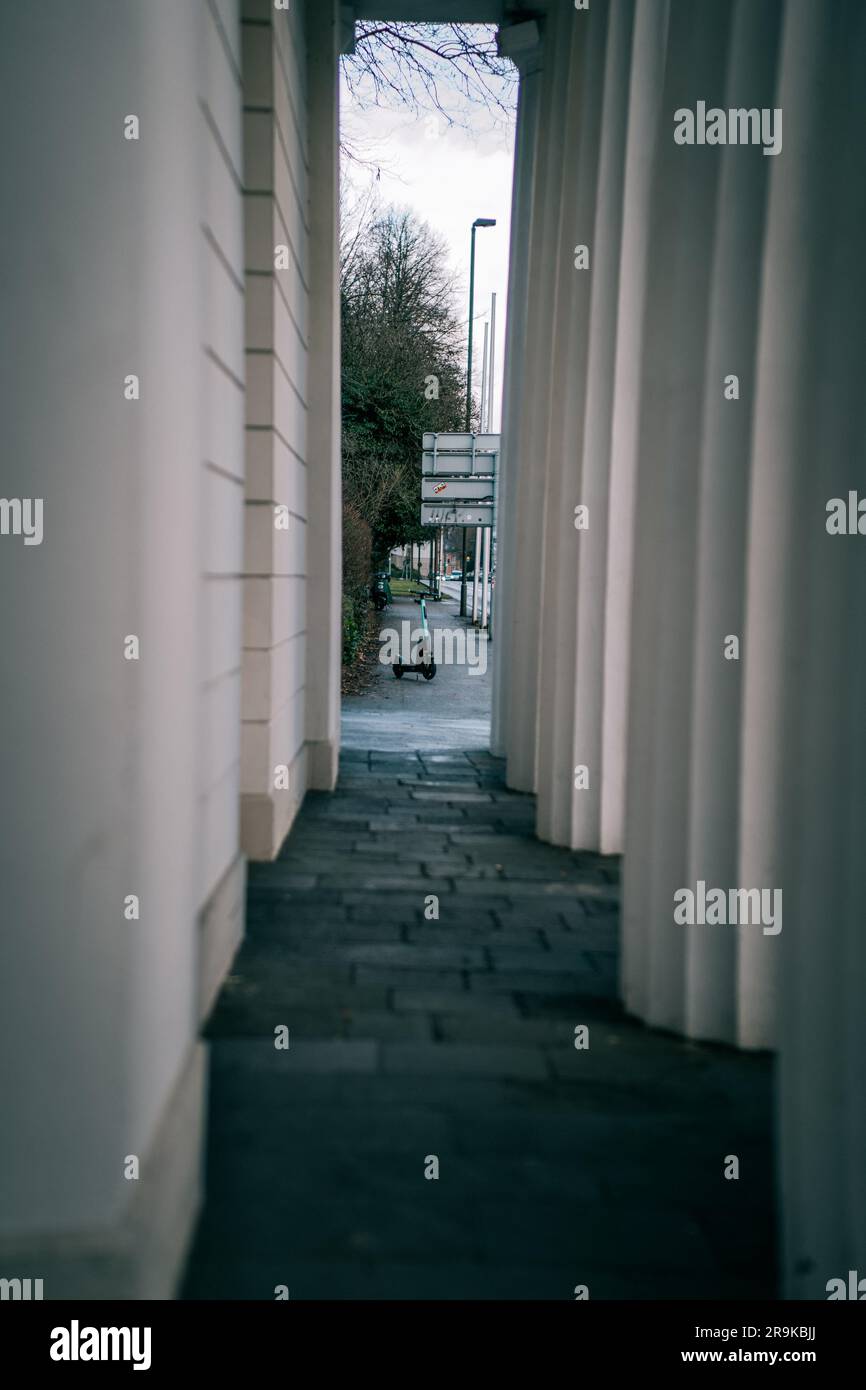 An open, narrow walkway in the evening Stock Photo - Alamy
